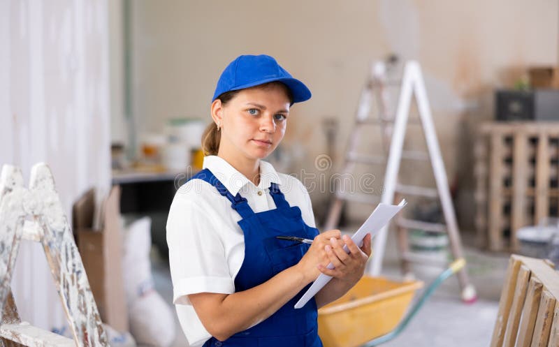 Woman Construction Manager Checking Project Documentation, Using Laptop ...