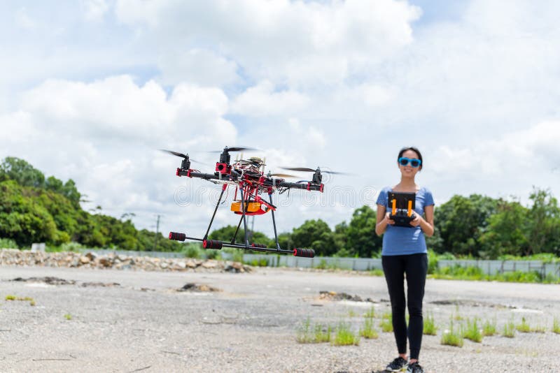 Woman controlling drone stock image. Image of outside - 94554327