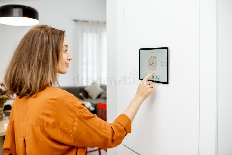 Woman Controlling Heating with a Smart Devices Stock Photo - Image of ...