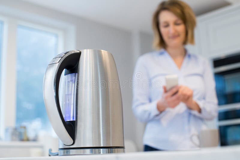 Woman Controlling Smart Kettle Using App on Mobile Phone Stock Image ...