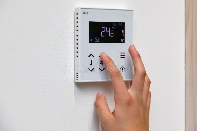 The Woman Controls the Temperature in the House. Air Conditioning and ...