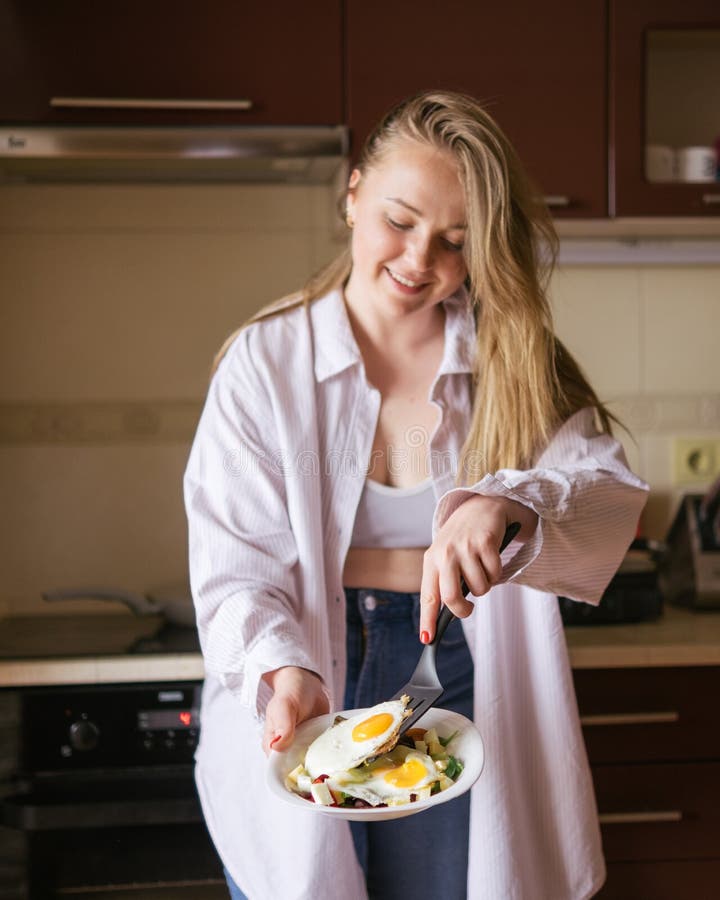 Woman Cooking Breakfast on Her Kitchen at Home. Focus on Tthe Eggs on ...