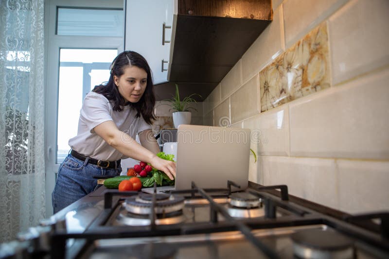 Woman Cooking Checking Recipe at Laptop Stock Image - Image of ...