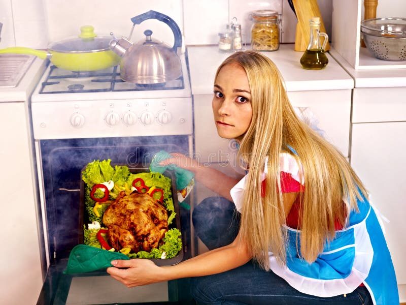 Woman Cooking Chicken at Kitchen. Stock Photo - Image of kitchen, food ...