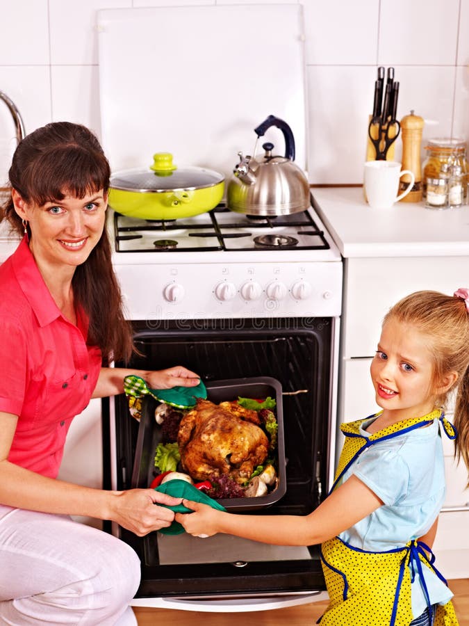 Woman Cooking Chicken at Kitchen. Stock Photo - Image of child, chicken ...