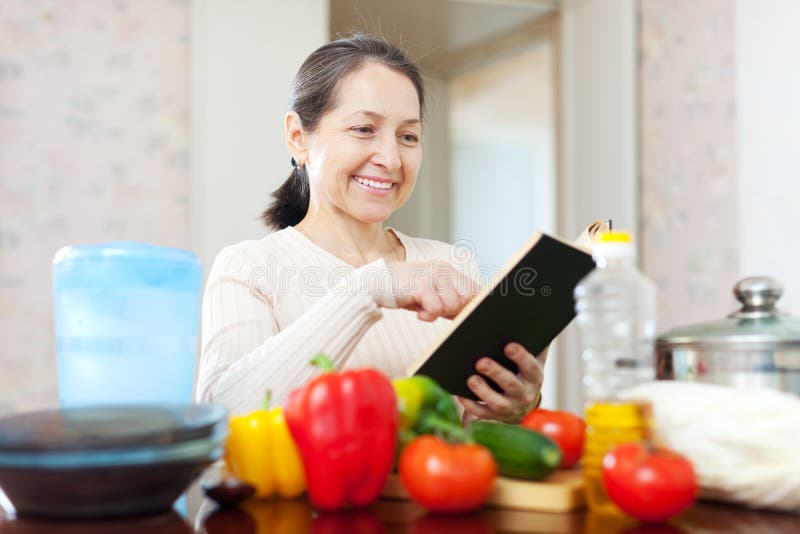 Woman Cooking with Cookbook in the Kitchen Stock Photo - Image of home ...