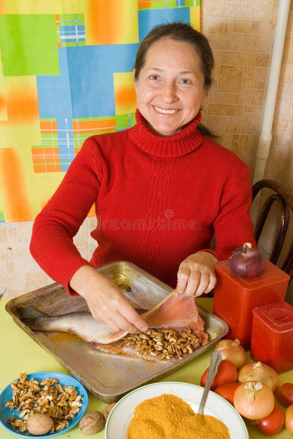 Woman is cooking fish stock photo. Image of fish, female - 16392220