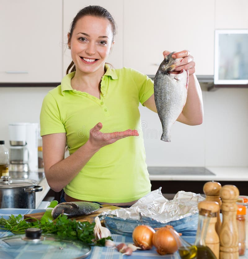 Woman cooking fish at home stock photo. Image of cook - 53374622