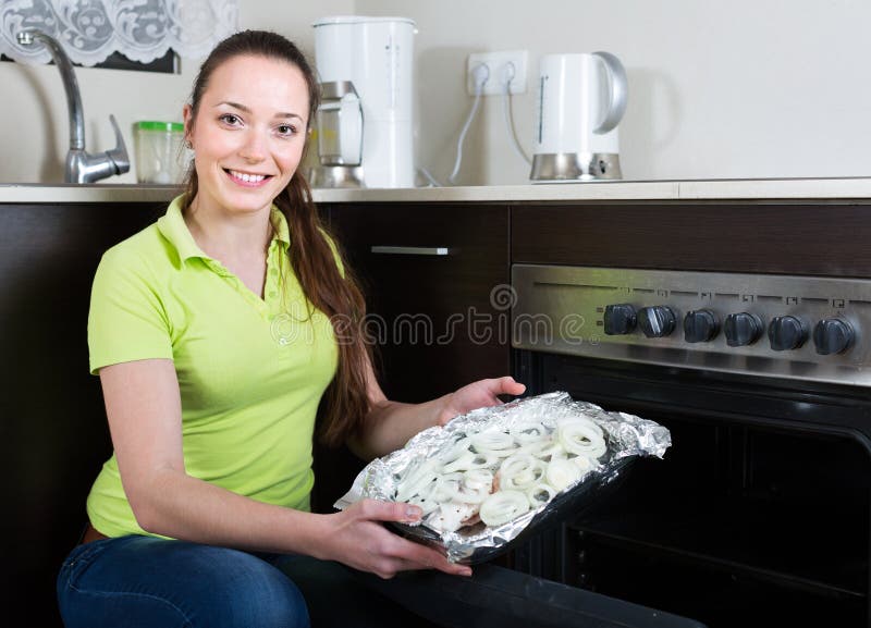 Woman cooking fish at home stock photo. Image of bake - 74453094