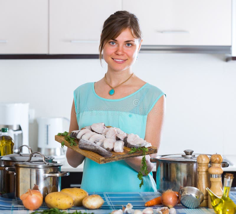 Woman Cooking Fish in Kitchen Stock Photo - Image of girl, maid: 66488448