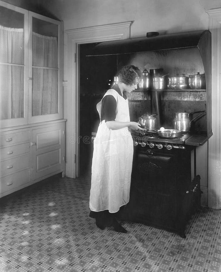 Woman Cooking on Antique Stove Stock Image - Image of busy, apron: 52004613
