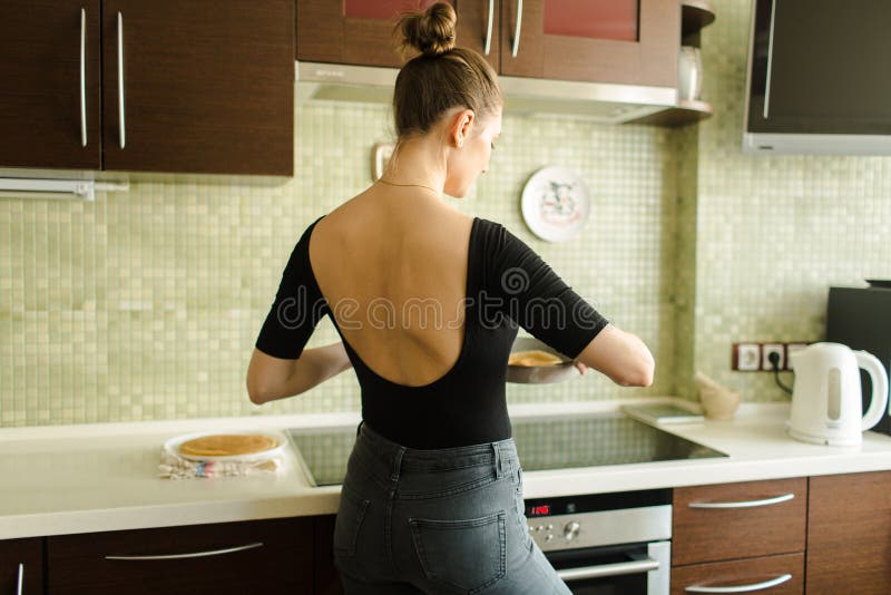 The Woman is Cooking in the Kitchen, the Back View Stock Photo - Image ...