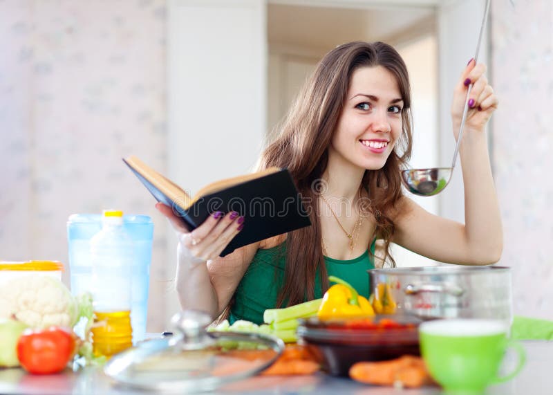 Woman Cooking with Ladle and Cookbook Stock Photo - Image of cook, read ...