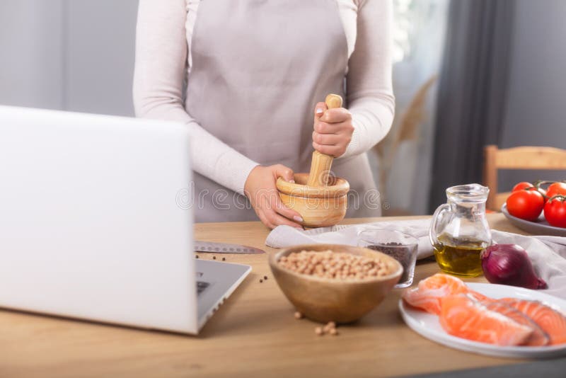 Woman Cooking Lunch Using the Computer To Watch Virtual Culinary Class ...