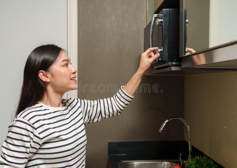 Woman Cooking with a Microwave in Kitchen Room Stock Photo - Image of ...