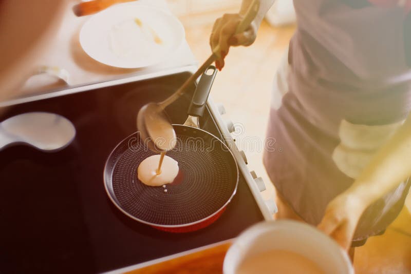 A Woman is Cooking Pancakes in the Kitchen. Stock Image - Image of ...