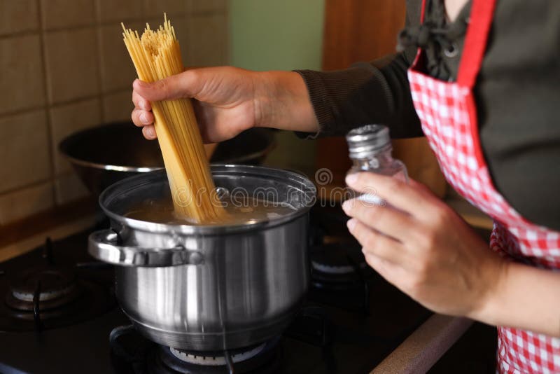 Woman Cooking Spaghetti on Stove in Kitchen Stock Photo - Image of ...