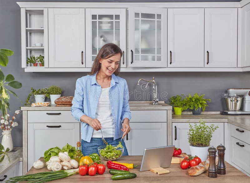 Woman Cooking while Watching the Digital Tablet Stock Image - Image of ...