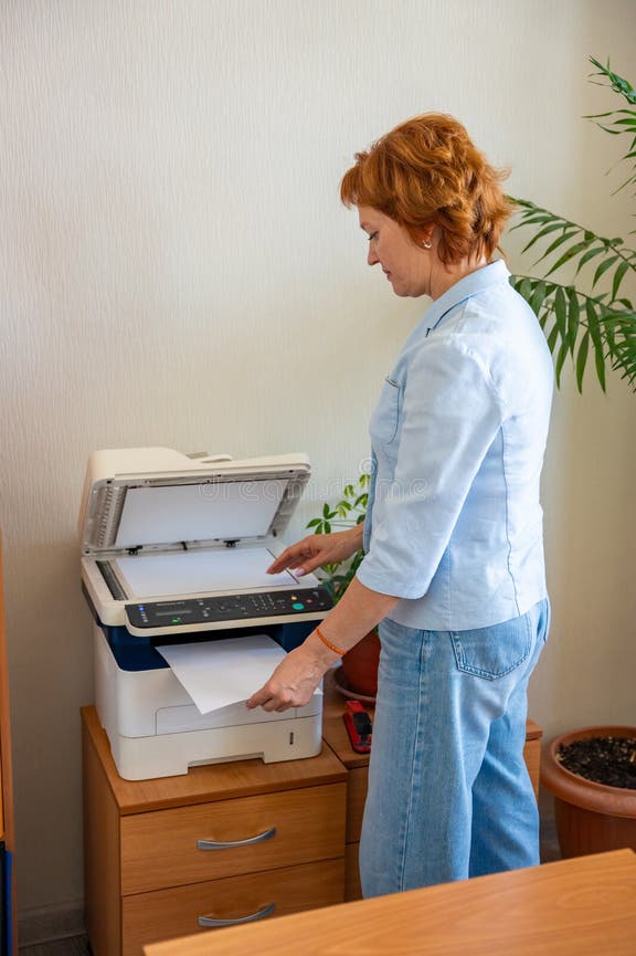 Woman Copying Documents Using an Office Printer in a Realistic ...