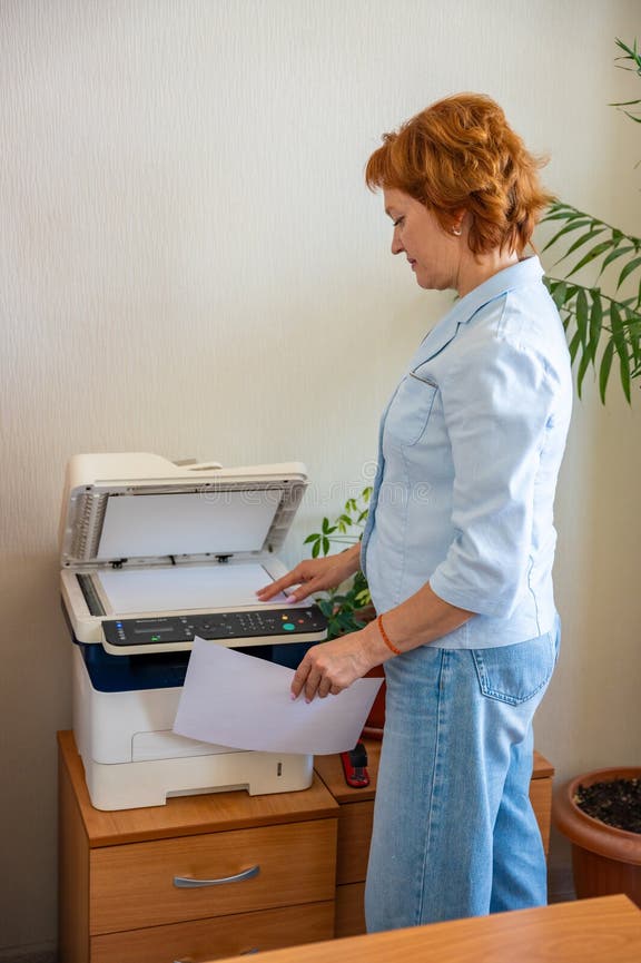 Woman Copying Documents Using an Office Printer in a Realistic ...