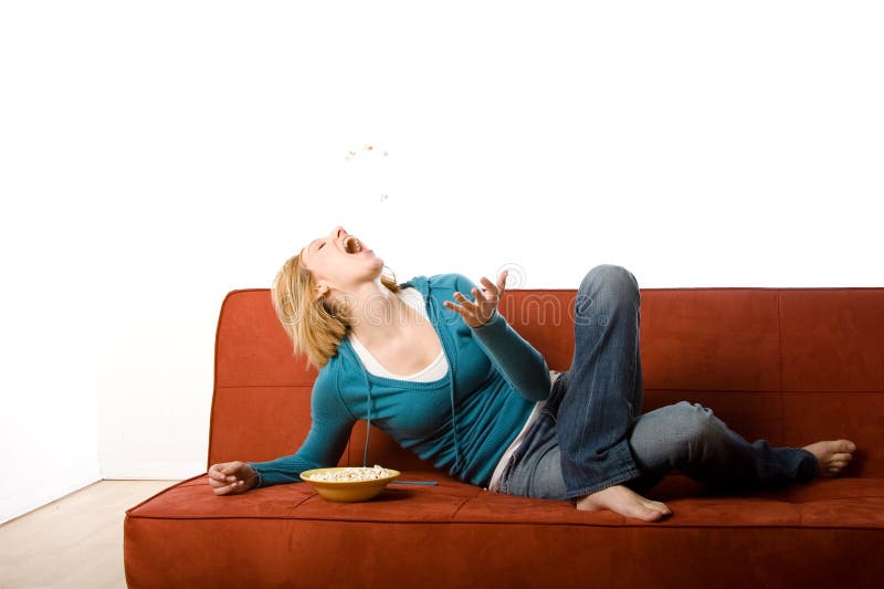 Woman eating on couch stock photo. Image of blue, brown - 2256588