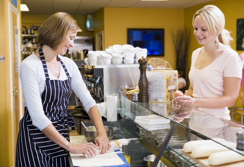 Woman at Counter in Restaurant Serving Customer Stock Photo - Image of ...