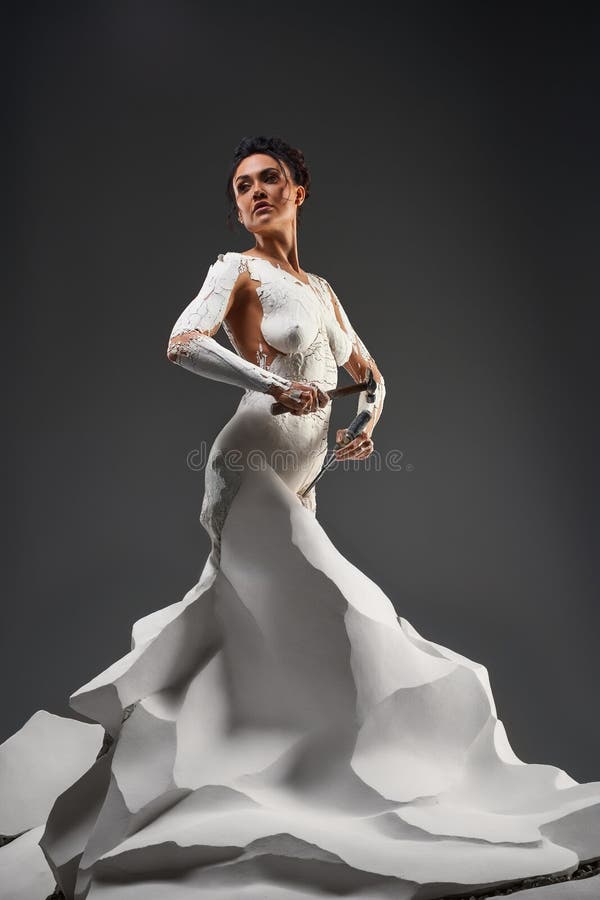 Woman Covered in White Paint Holds a Hammer in a Studio Stock Photo ...
