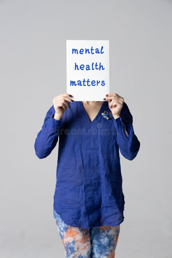 Woman Covering Her Face with a White Poster with the Words Mental ... Woman Covering Her Face with a White Poster with the Words Mental ...