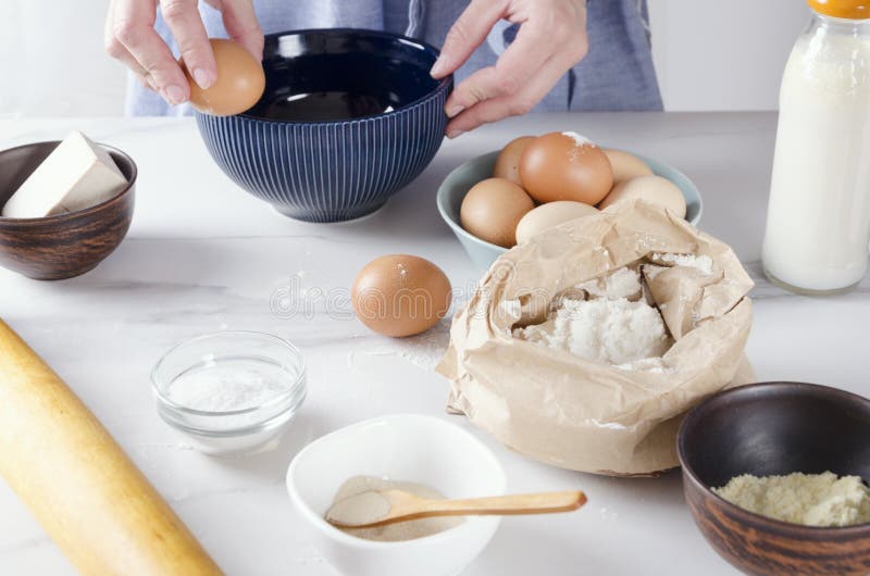 Woman Cracking an Egg into the Blue Bowl, Baking Cake Process.Base ...