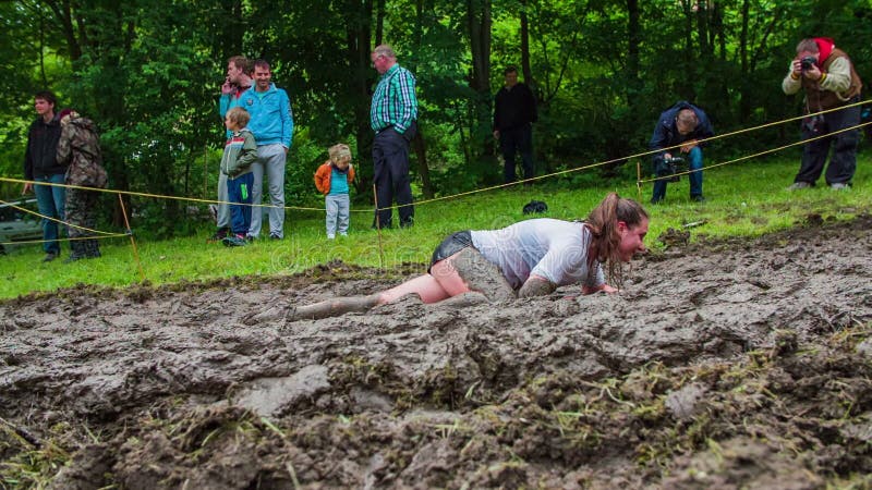 Woman Crawling through Mud As Part of Obstacle Course Stock Footage ...