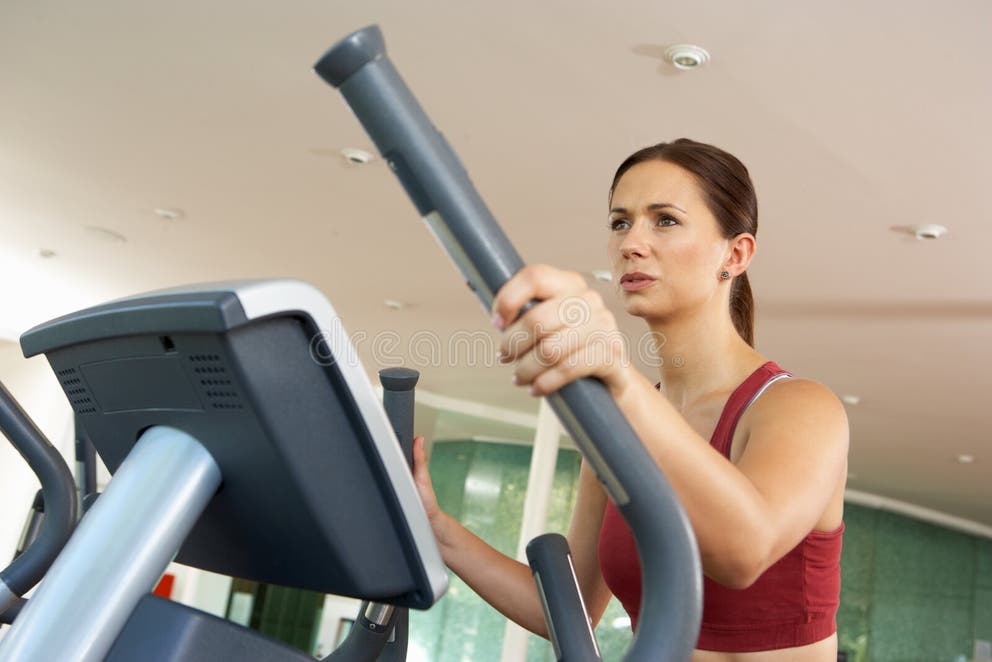 Woman on Cross Trainer Machine Stock Photo - Image of working, keeping ...