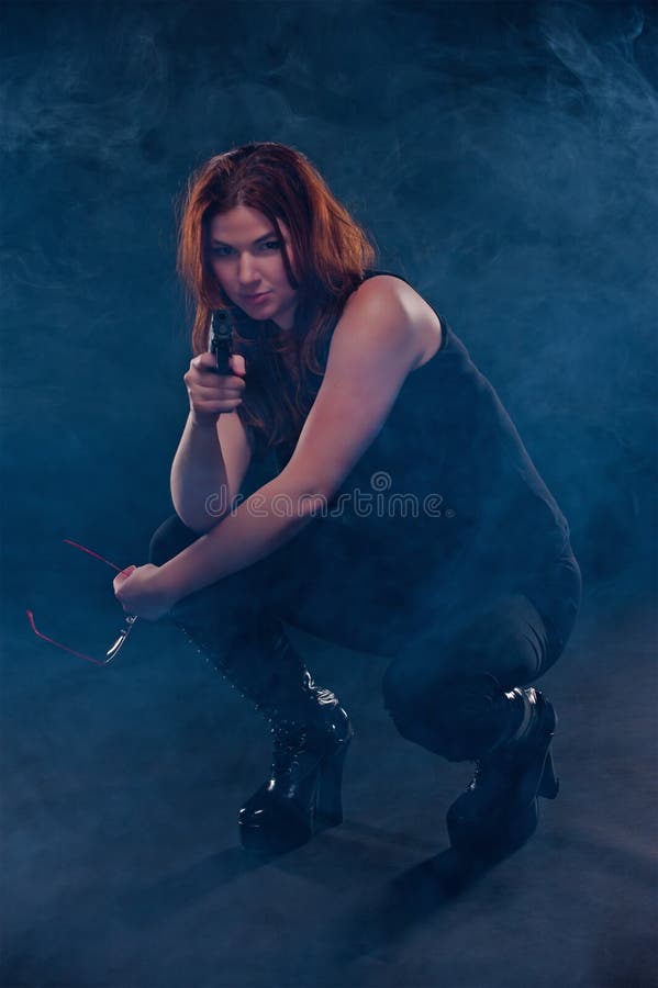 Woman Crouching Down Aiming a Gun Stock Photo - Image of beautiful ...