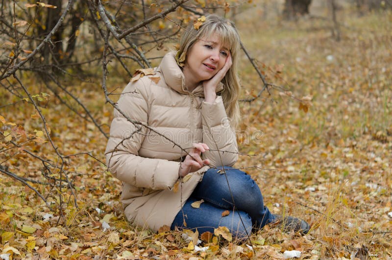 A Woman Crying in the Autumn Forest with Yellow Leaves Stock Image ...