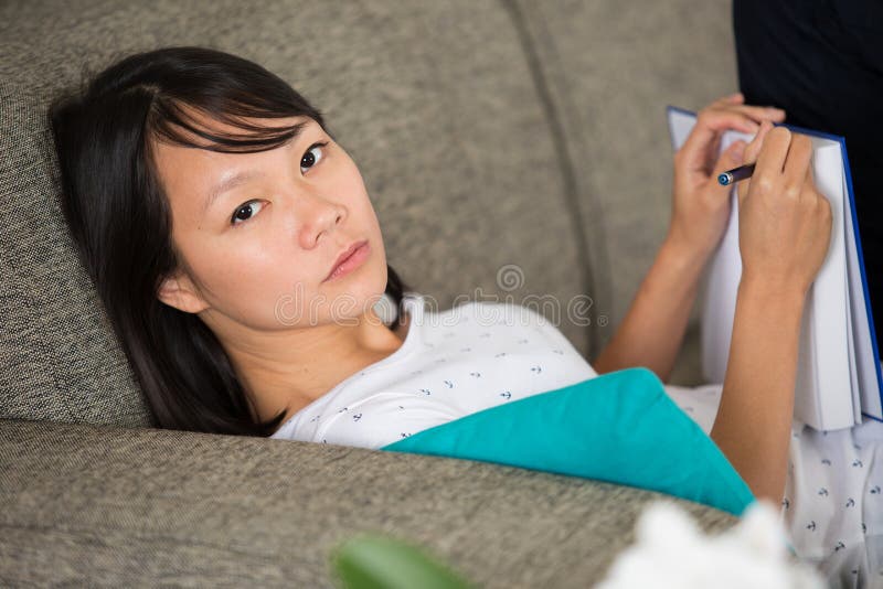 Woman Crying on Sofa while Taking Notes Stock Photo - Image of crying ...