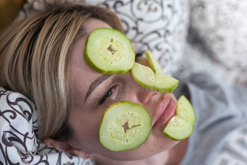 A Woman with a Cucumber on Her Face Stock Photo - Image of body, mask ...