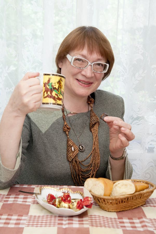 Woman with a Cup in the Kitchen Stock Photo - Image of mother, looking ...