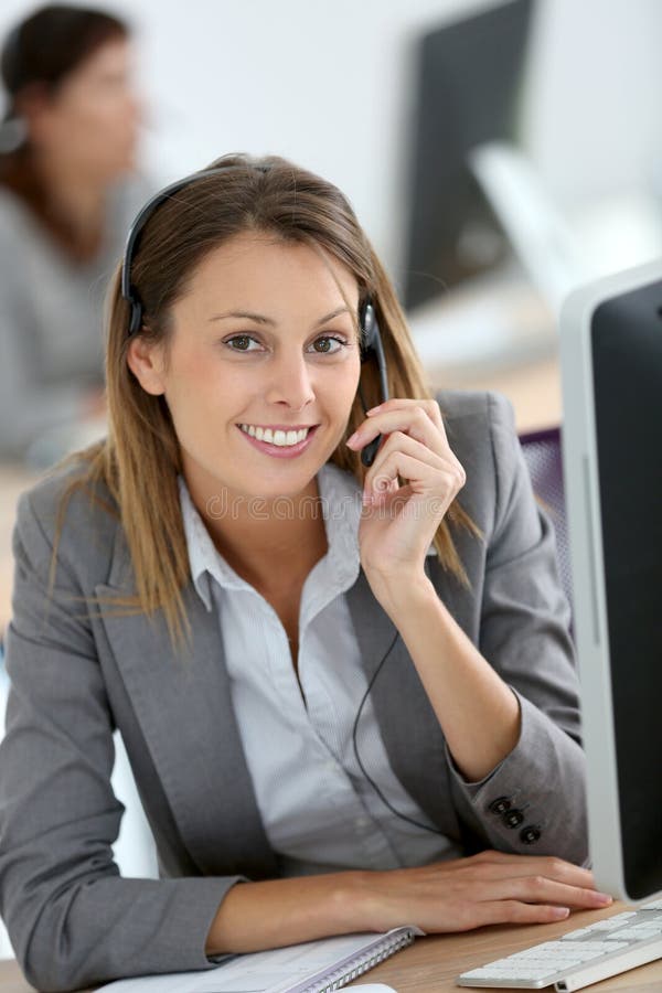 Smiling Customer Service Assistant at Reception Desk Stock Image ...