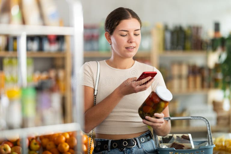 Woman Customer at Shop Scans QR Code on Pickled Tomatoes and Cucumbers ...