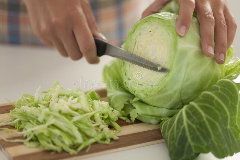 Woman Cuts Cabbage on Cutting Board in Kitchen Stock Photo - Image of ...