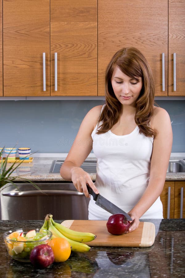 Woman cutting an apple stock photo. Image of cheerful - 10314024