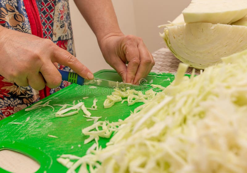 Woman Cutting Cabbage with a Knife in the Kitchen Stock Photo - Image ...