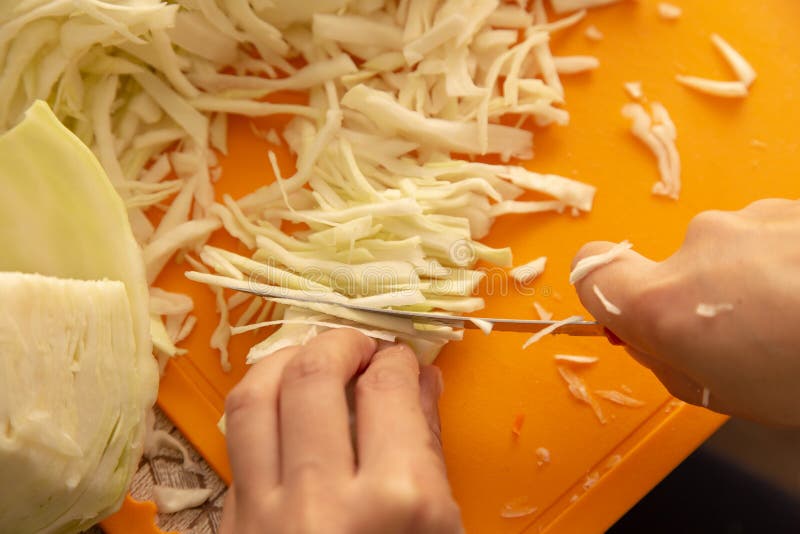 Woman Cutting Cabbage with a Knife in the Kitchen Stock Photo - Image ...
