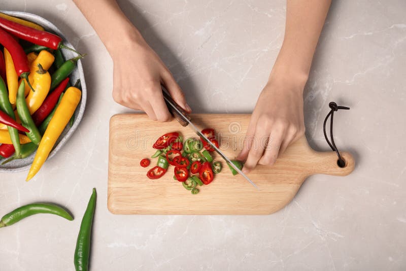 Woman Cutting Chili Peppers at Table Stock Photo - Image of hands ...