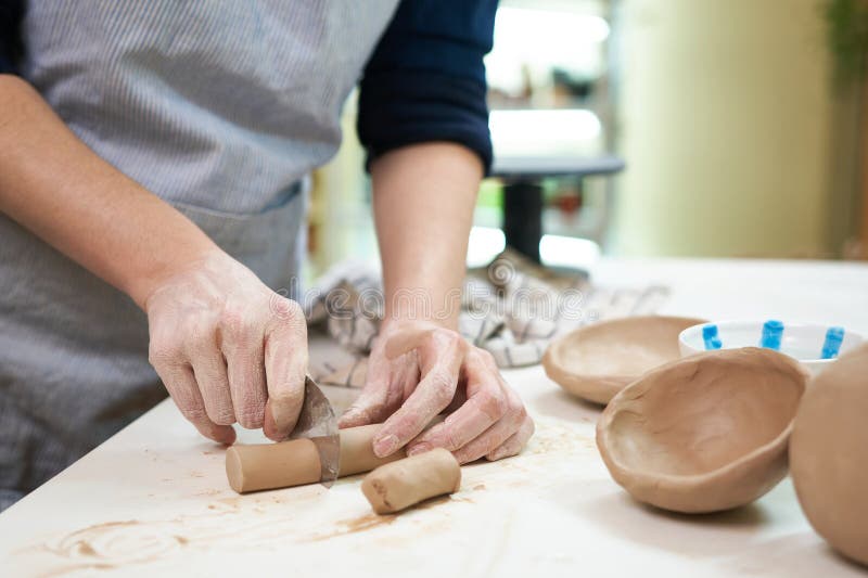 Woman Cutting Clay with Blade Standing Behind Table in Studio Stock ...