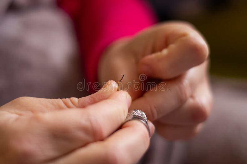 Woman Cutting and Knotting a Thread on a Needle Stock Image - Image of ...