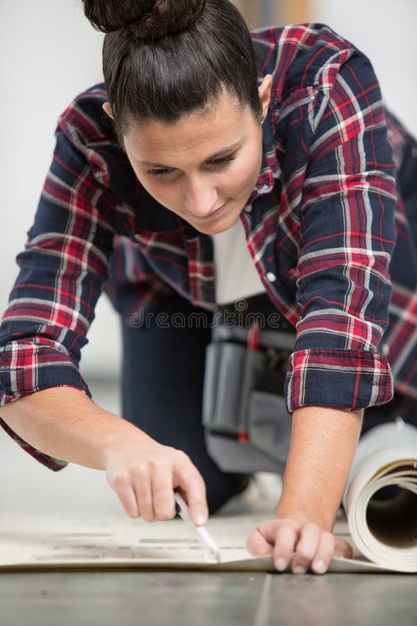 Woman cutting piece carpet stock photo. Image of improvement - 234518582
