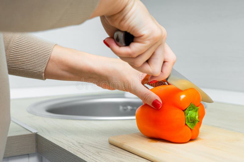 Woman Cutting Red Bell Pepper with Knife on Kitchen Board. Stock Photo ...