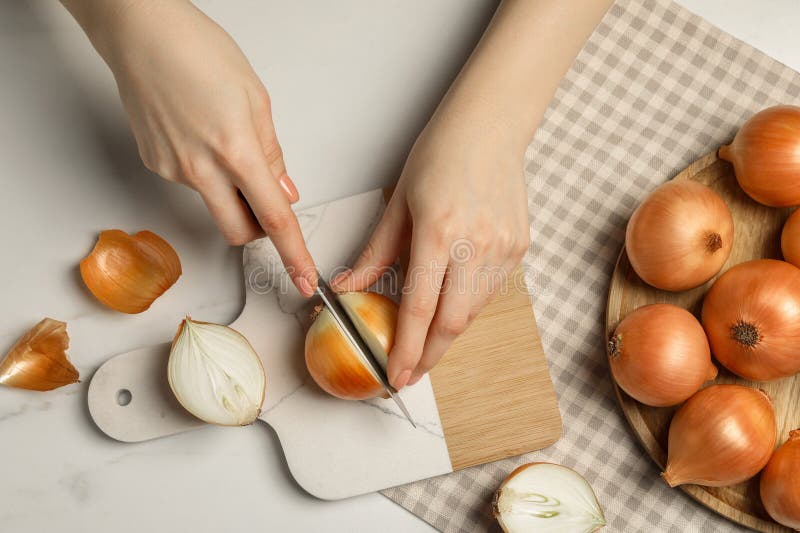 Woman Cutting Ripe Onion at White Marble Table, Top View Stock Image ...