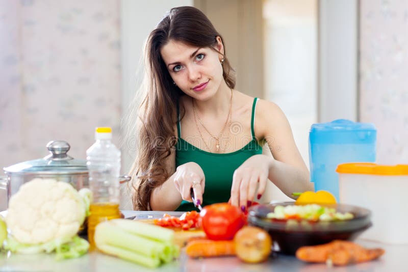 Woman Cutting Vegetables with Device at the Kitchen Table Stock Image ...