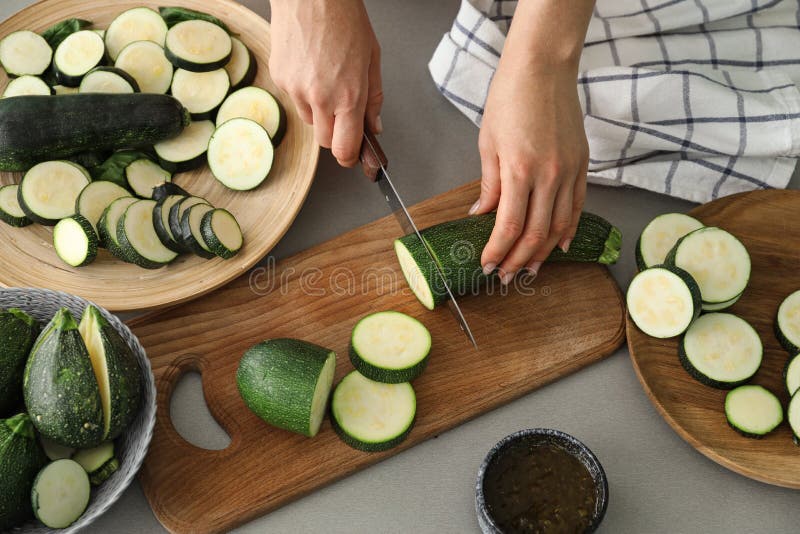 Woman Cutting Zucchini in Kitchen Stock Image - Image of knife ...